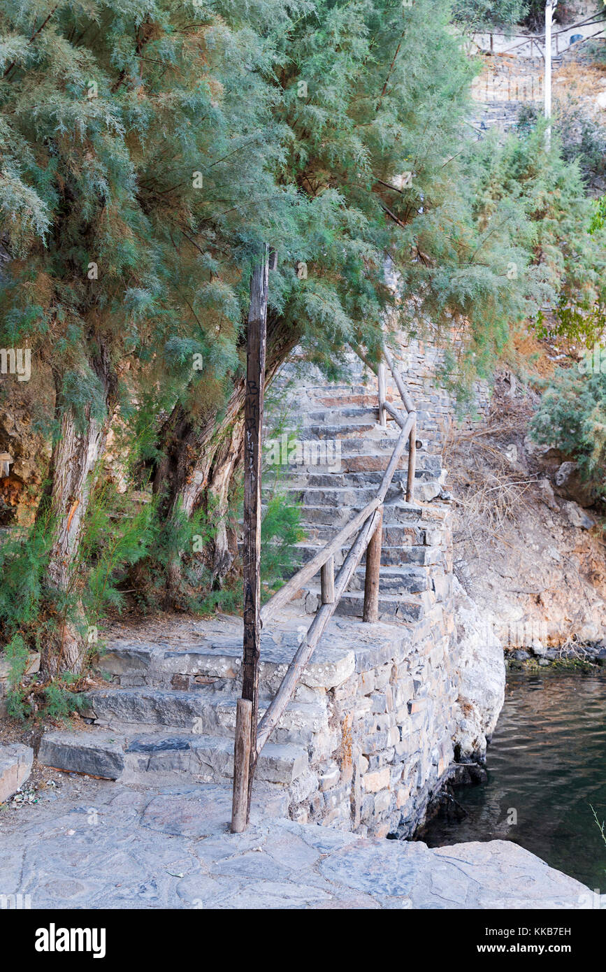 The old stone steps on a hill rising on either side grass. Stone stairs ...