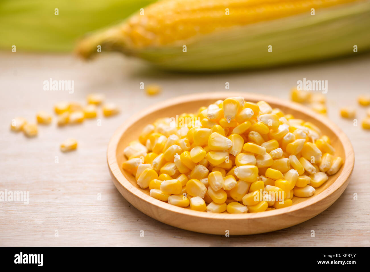 Sweet corn seeds on a wooden plate Stock Photo - Alamy