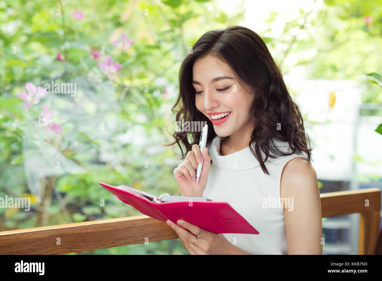 Beautiful asian girl writing notes in a desk at home Stock Photo - Alamy
