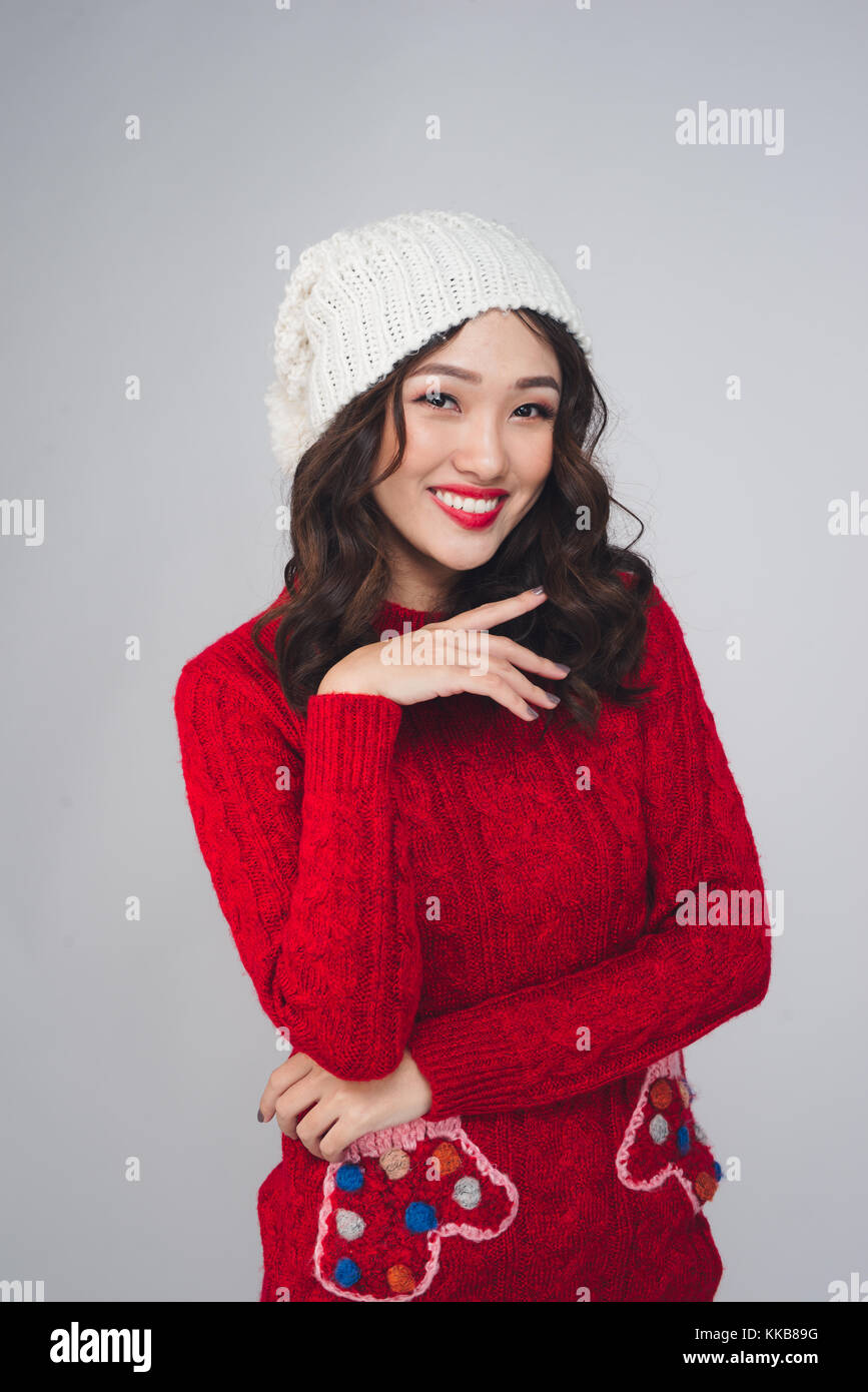 Beautiful smiling fashion model face with red lips in warm clothing ...