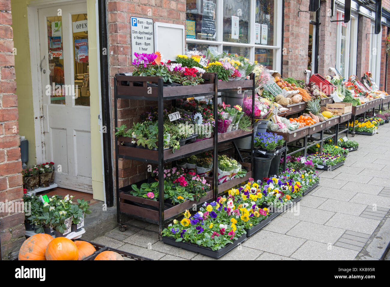 Grocery shop and outdoor display of flowers, fruit and vegetables ...