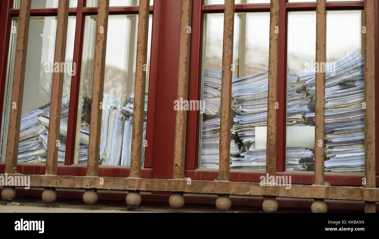 Behind the glass window are stacks of paper Stock Photo - Alamy