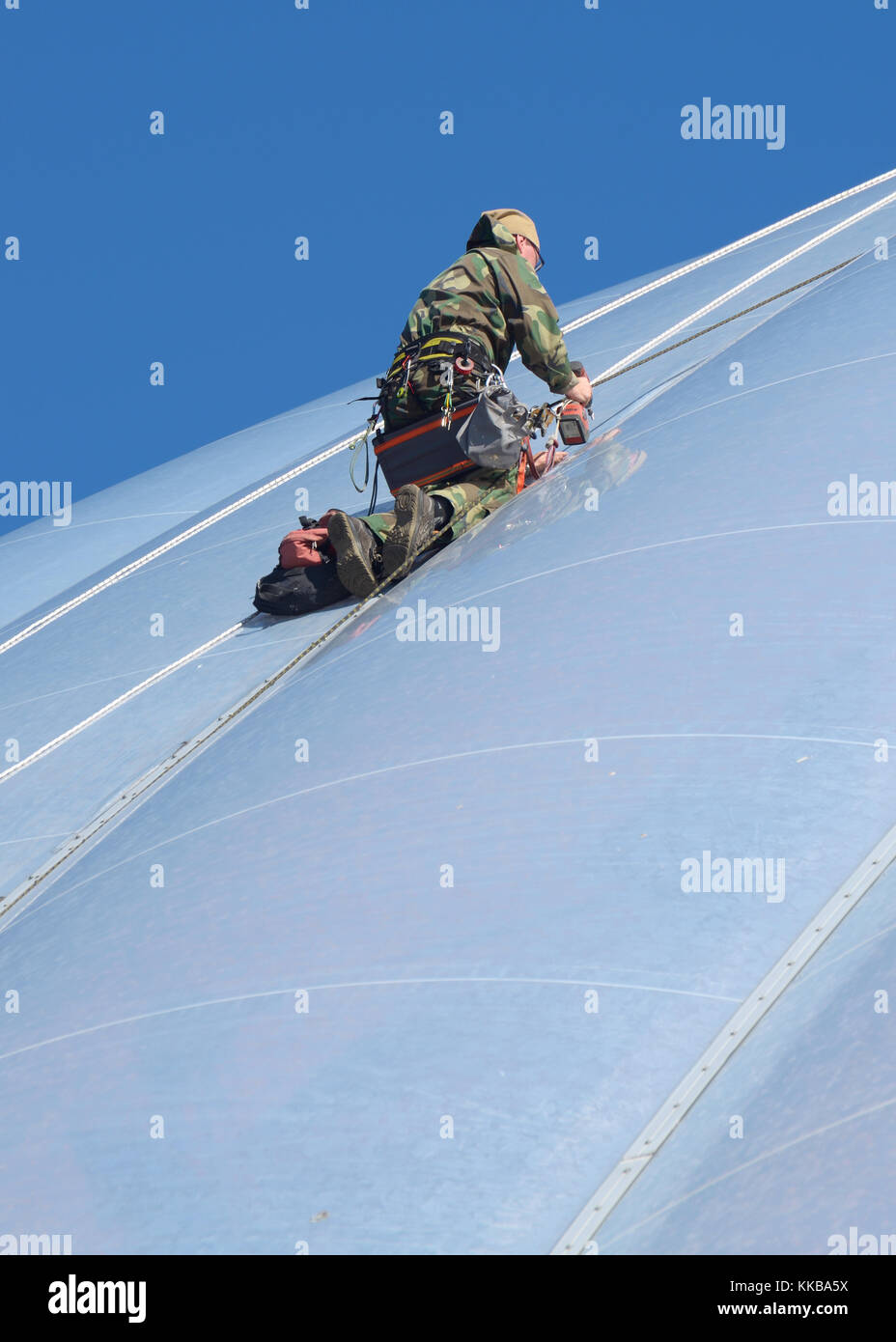 The climber is working on the roof.Working at height is dangerous Stock ...