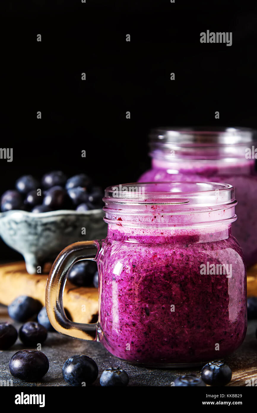 Fresh juicy blueberry smoothies in the glass. Simple background ...