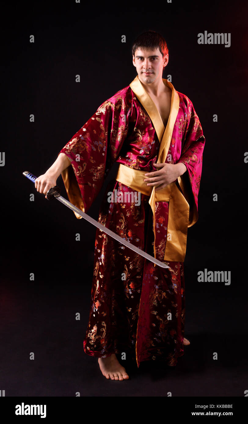 Young man holding samurai sword hi-res stock photography and images - Alamy