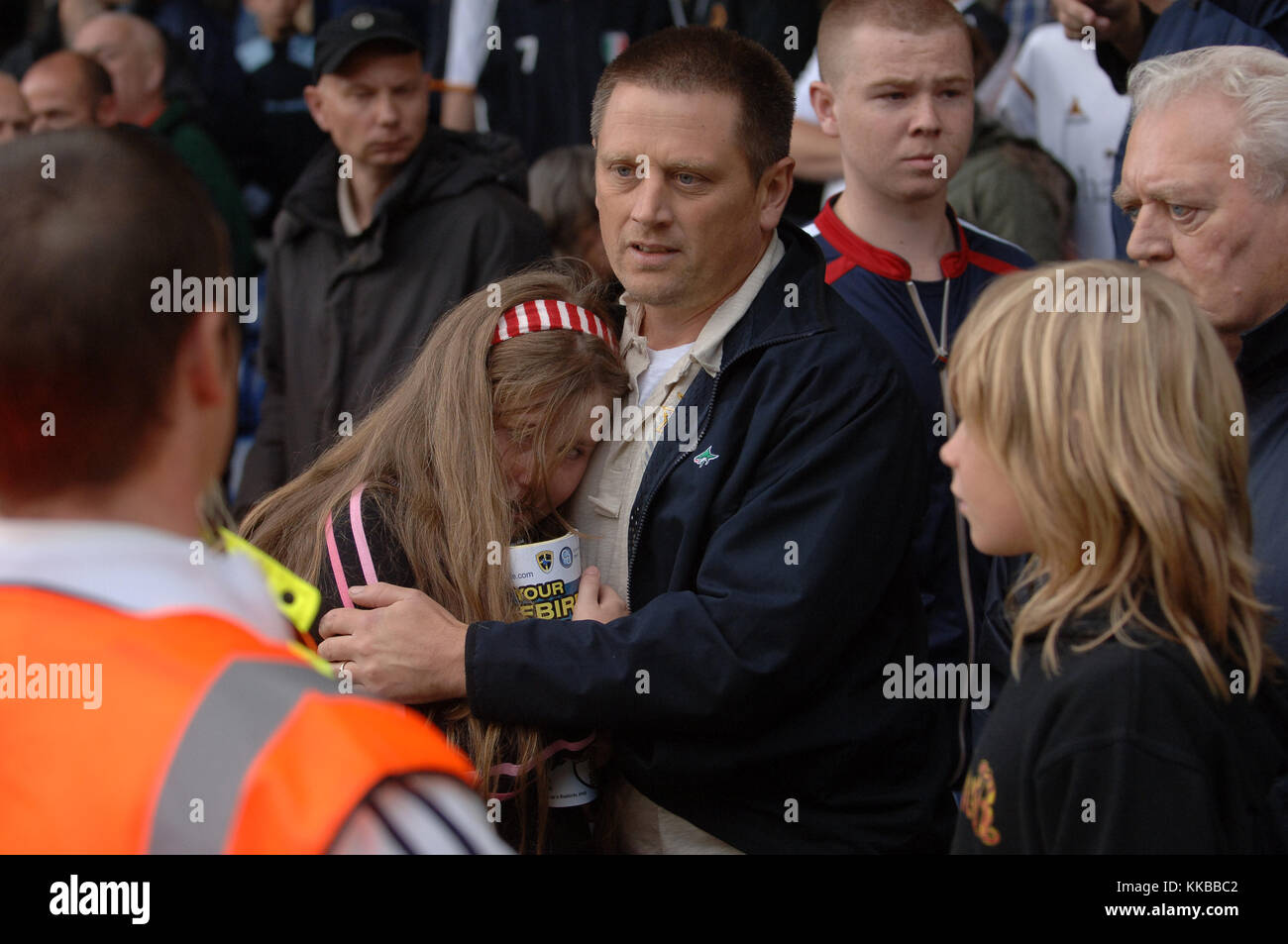 A young female football fan distressed by bad crowd behavior at Ninian ...
