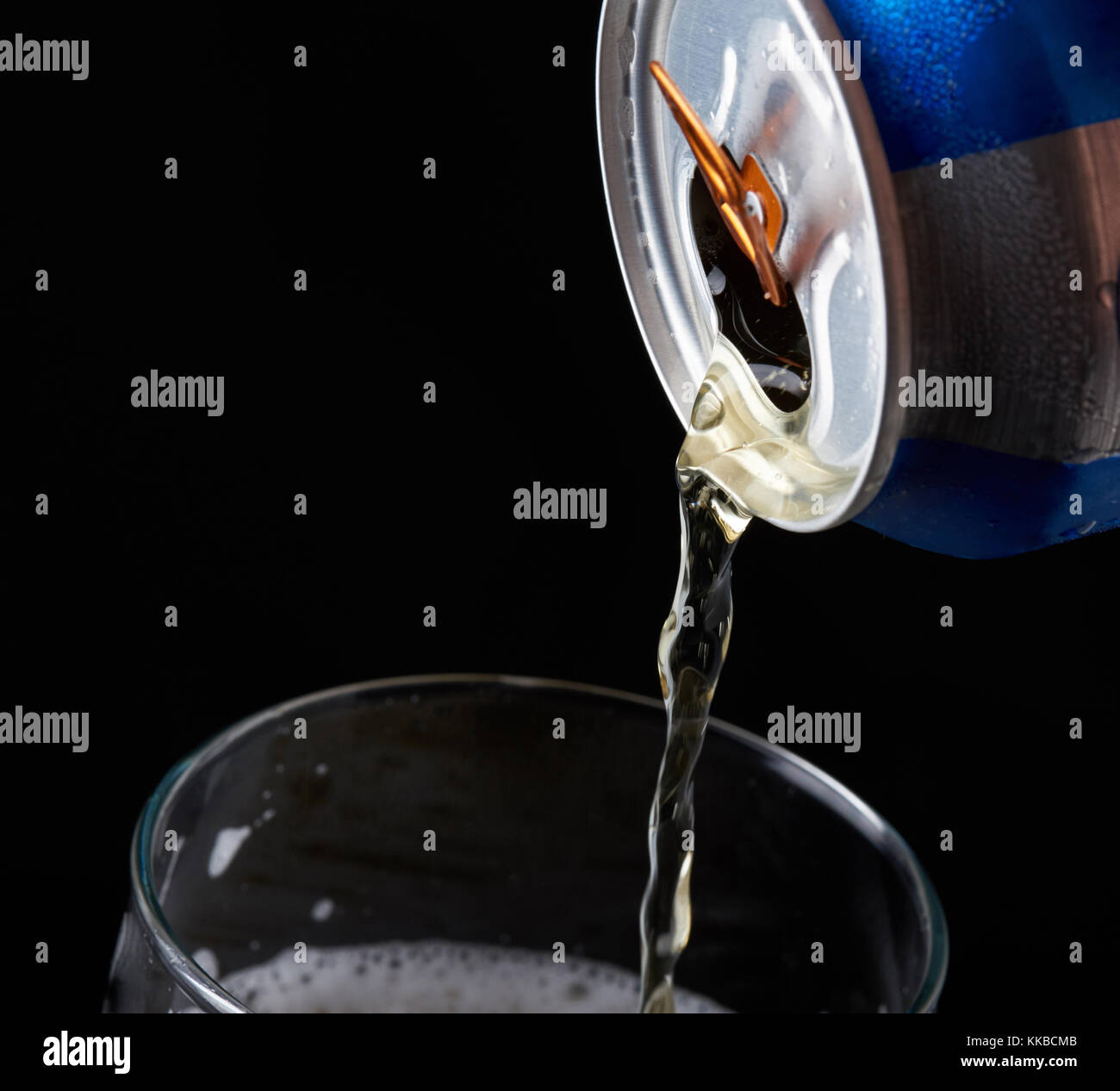 Pour cold beer from can isolated on black background Stock Photo - Alamy