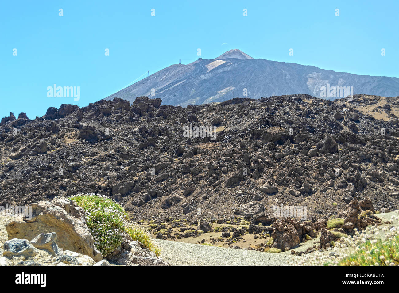 volcanic rocks mixed with desert sand, in the background Mount Teide ...
