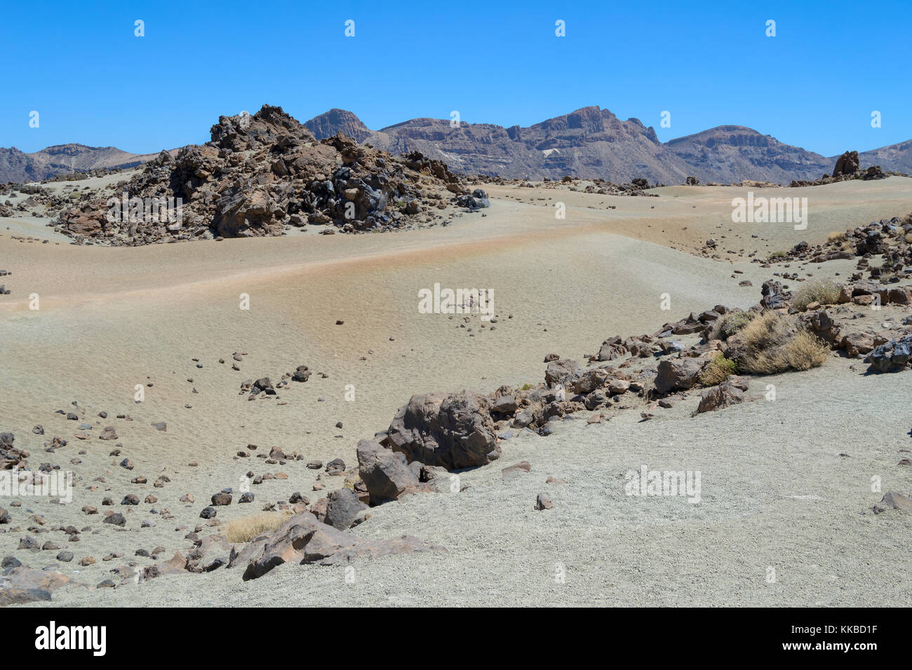 white desert sand and volcanic rocks at high altitude on Mount Teide ...