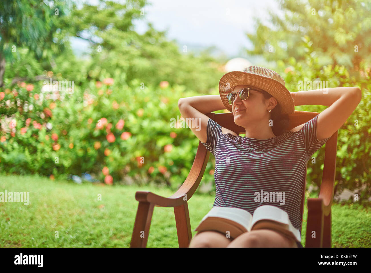 Summer vacation concept. Young woman sitting in backyard Stock Photo ...