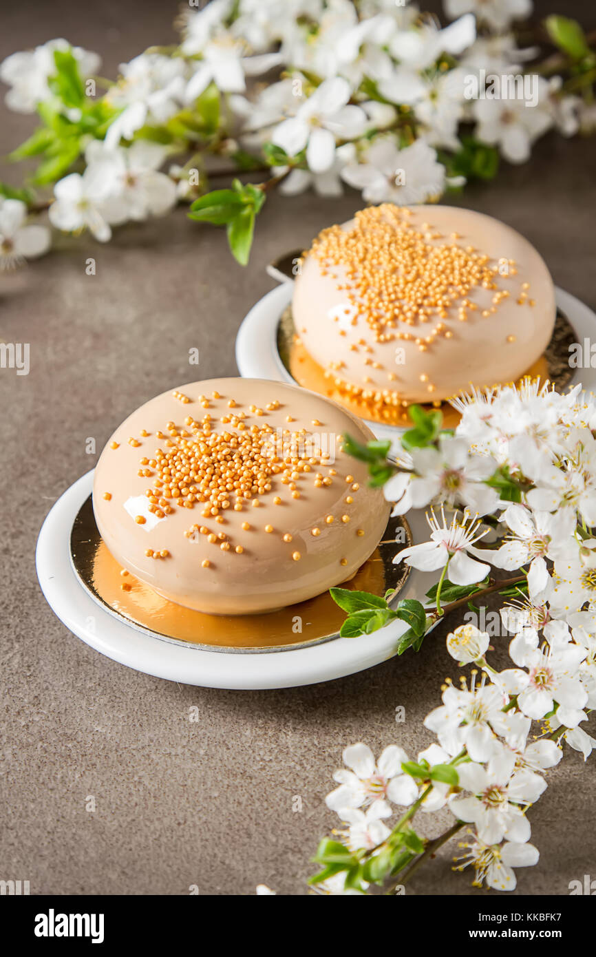 Fashionable mousse cake with a mirror glaze decorated with spring ...