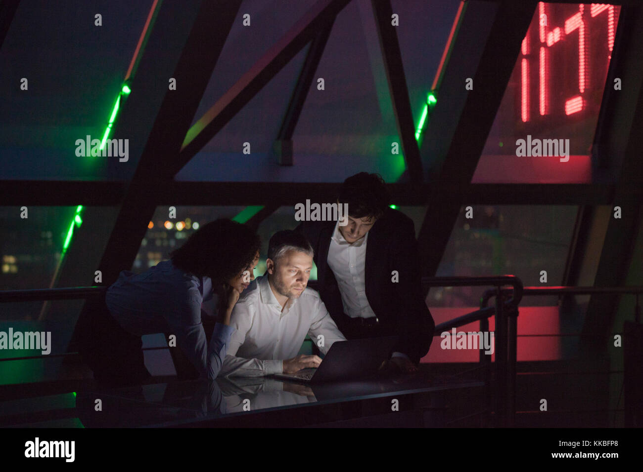 Group of business people working in a night office Stock Photo - Alamy