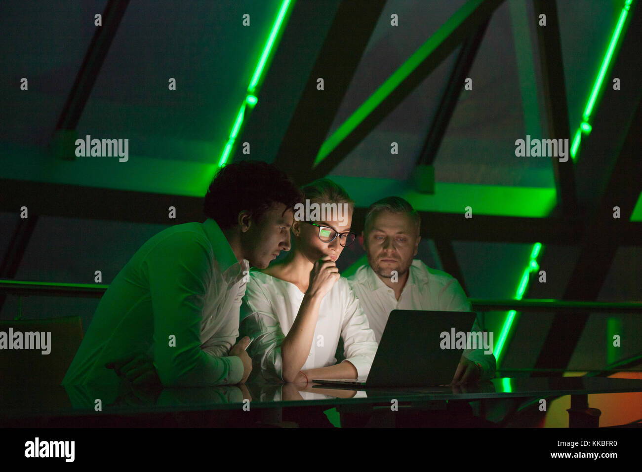 Group of business people working in a night office Stock Photo - Alamy