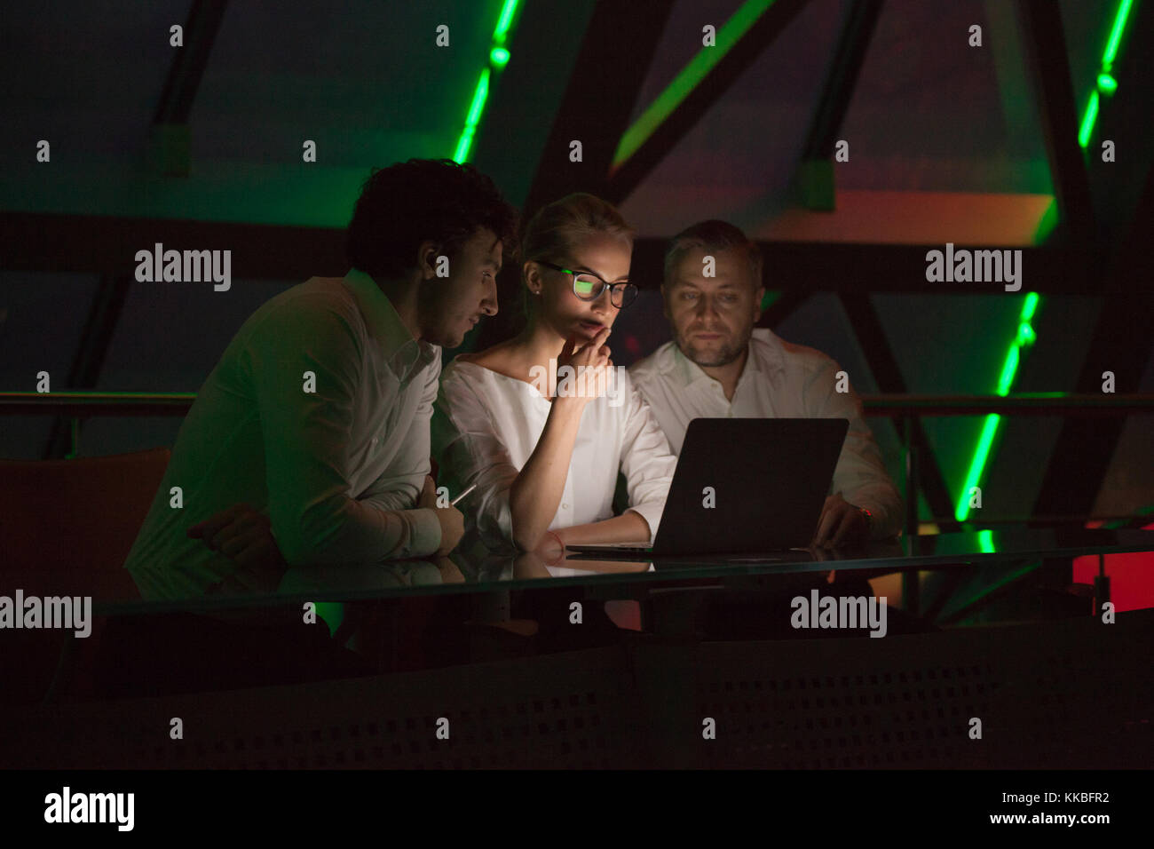 Group of business people working in a night office Stock Photo - Alamy