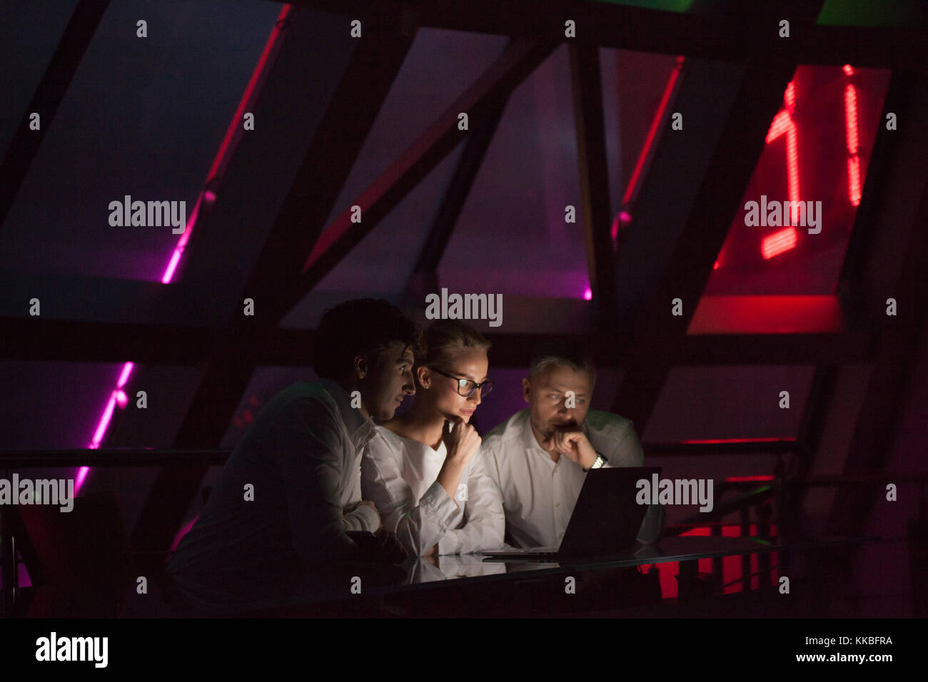 Group of business people working in a night office Stock Photo - Alamy