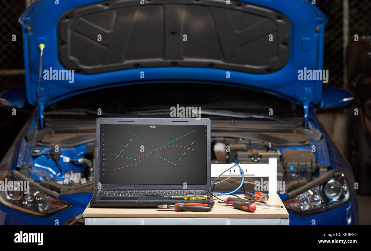 Checking modern car station with tools on blur vehicle background ...