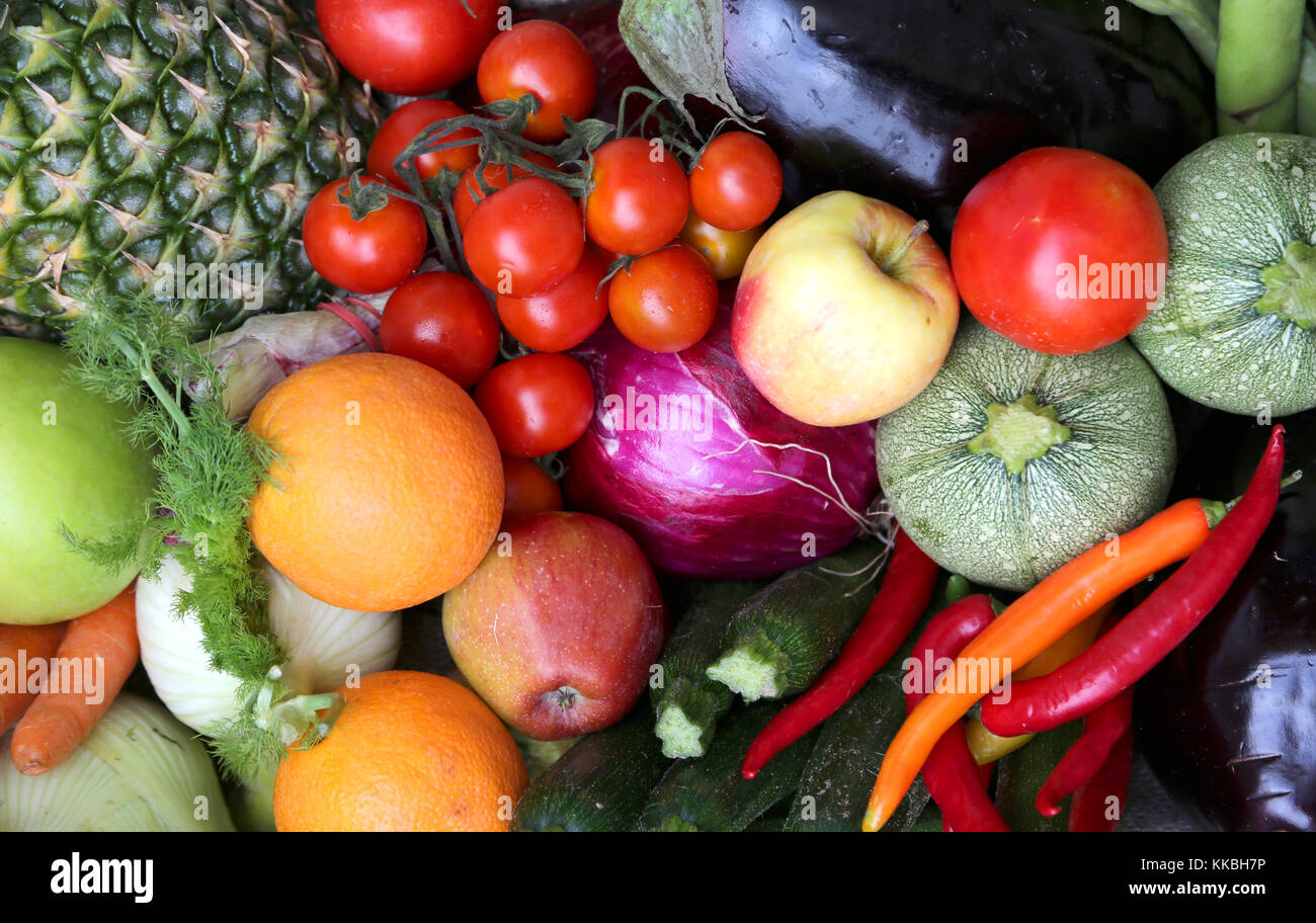 background of fresh fruits and vegetables like pineaple,carrots,apples ...