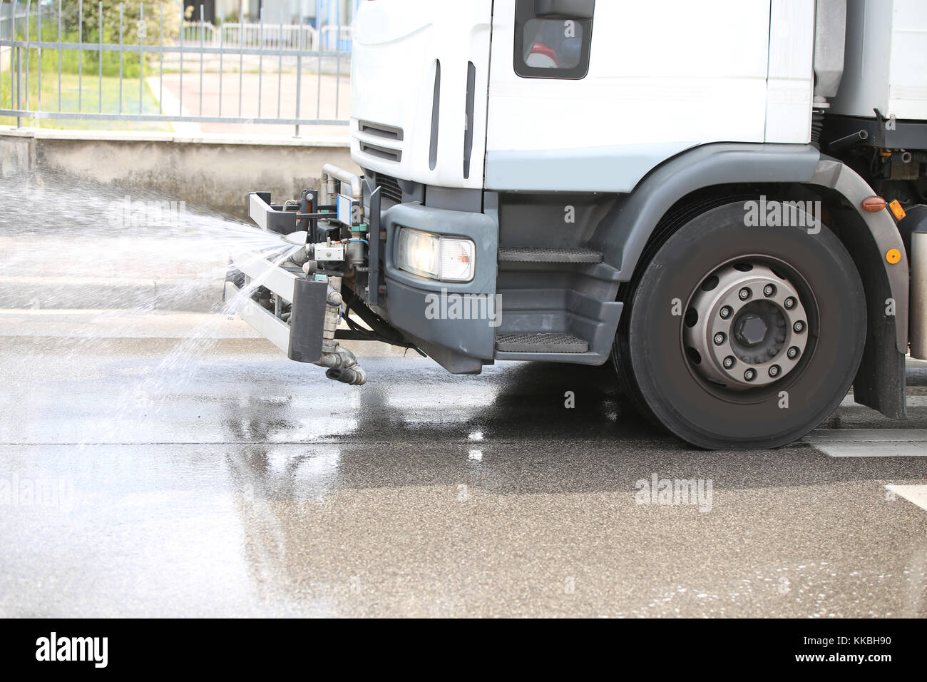 road cleaning trucks during asphalt washing in the city Stock Photo - Alamy