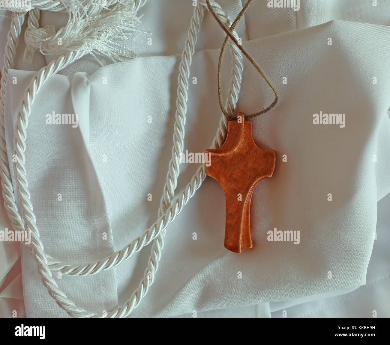 white tunic with wooden cross for religious rite Stock Photo - Alamy