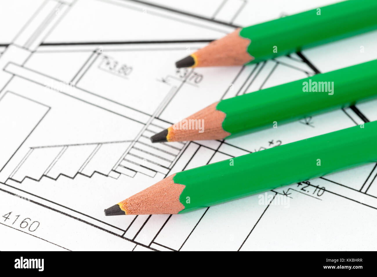 Three green pencils on architectural blueprint Stock Photo - Alamy