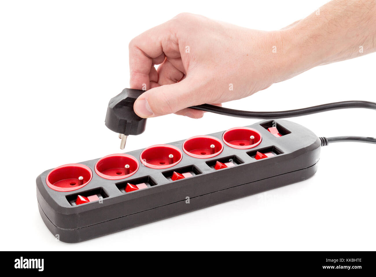 Hand putting plug in extension cord. Isolated on white background Stock ...