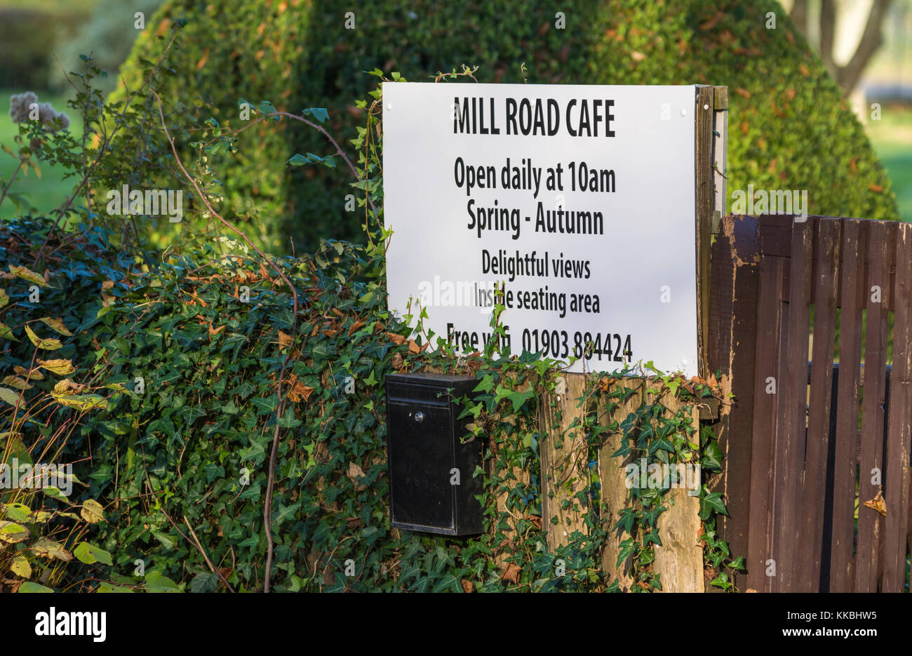 Cafe sign showing seasonal opening and closing times Stock Photo - Alamy