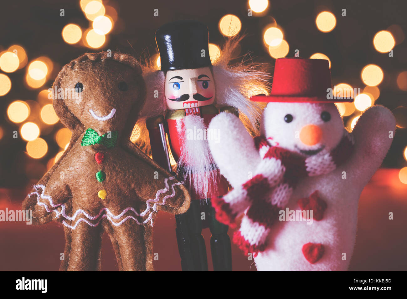 Festive snowman, nutcracker and gingerbread man decorations against a ...