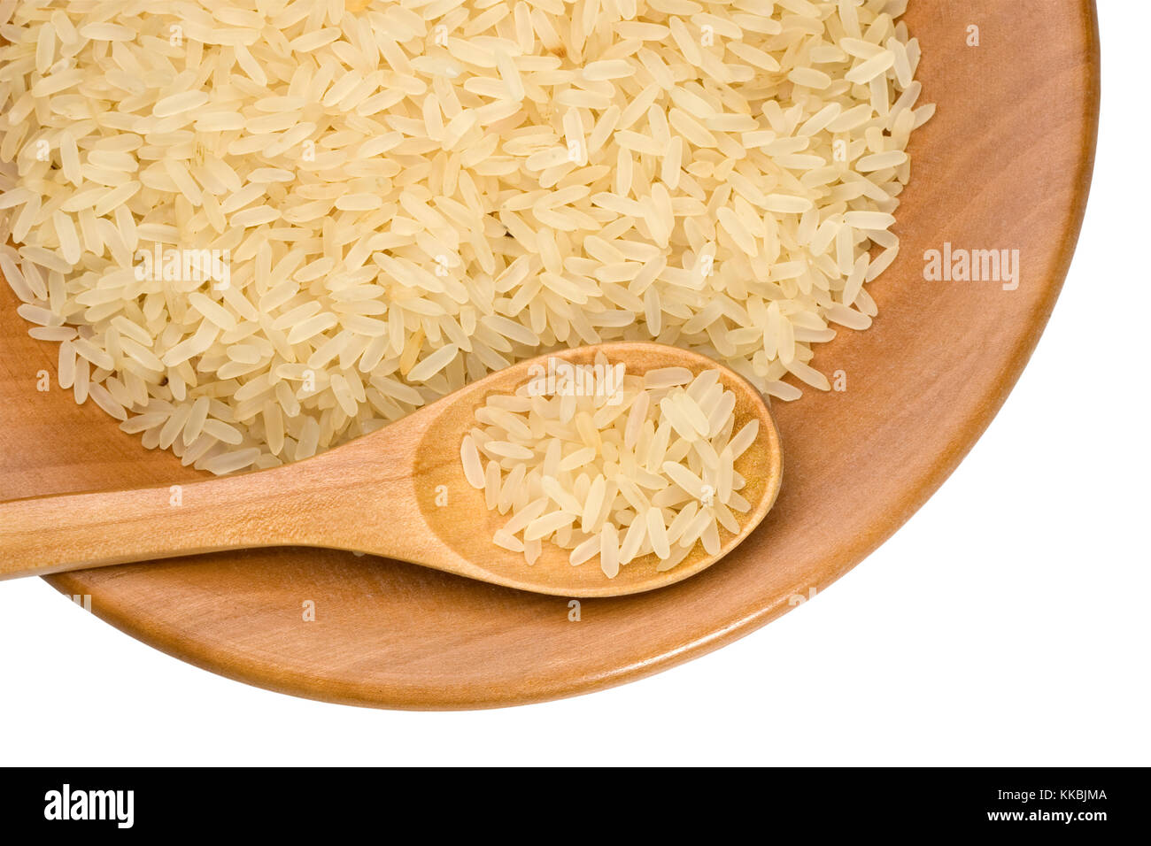 wooden plate with grains of rice on a white background with clipping ...