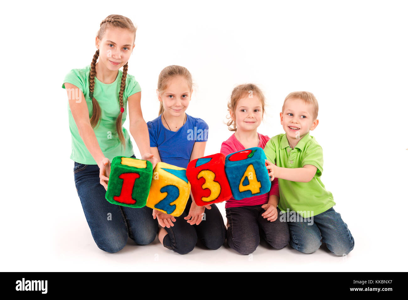 Happy kids holding blocks with numbers over white background Stock ...