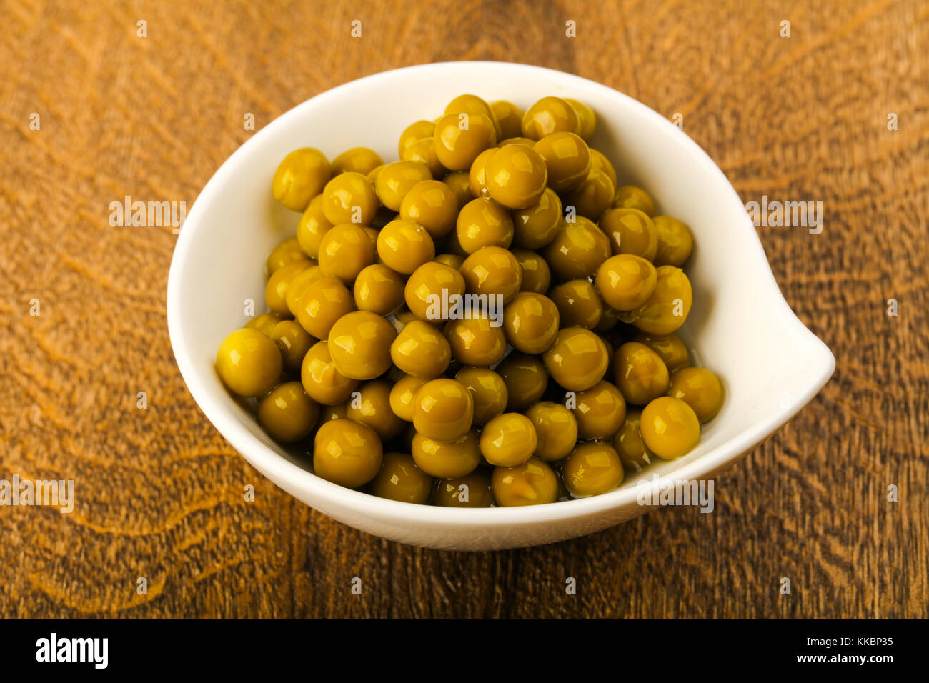 Pickled green pea on the wood background Stock Photo - Alamy