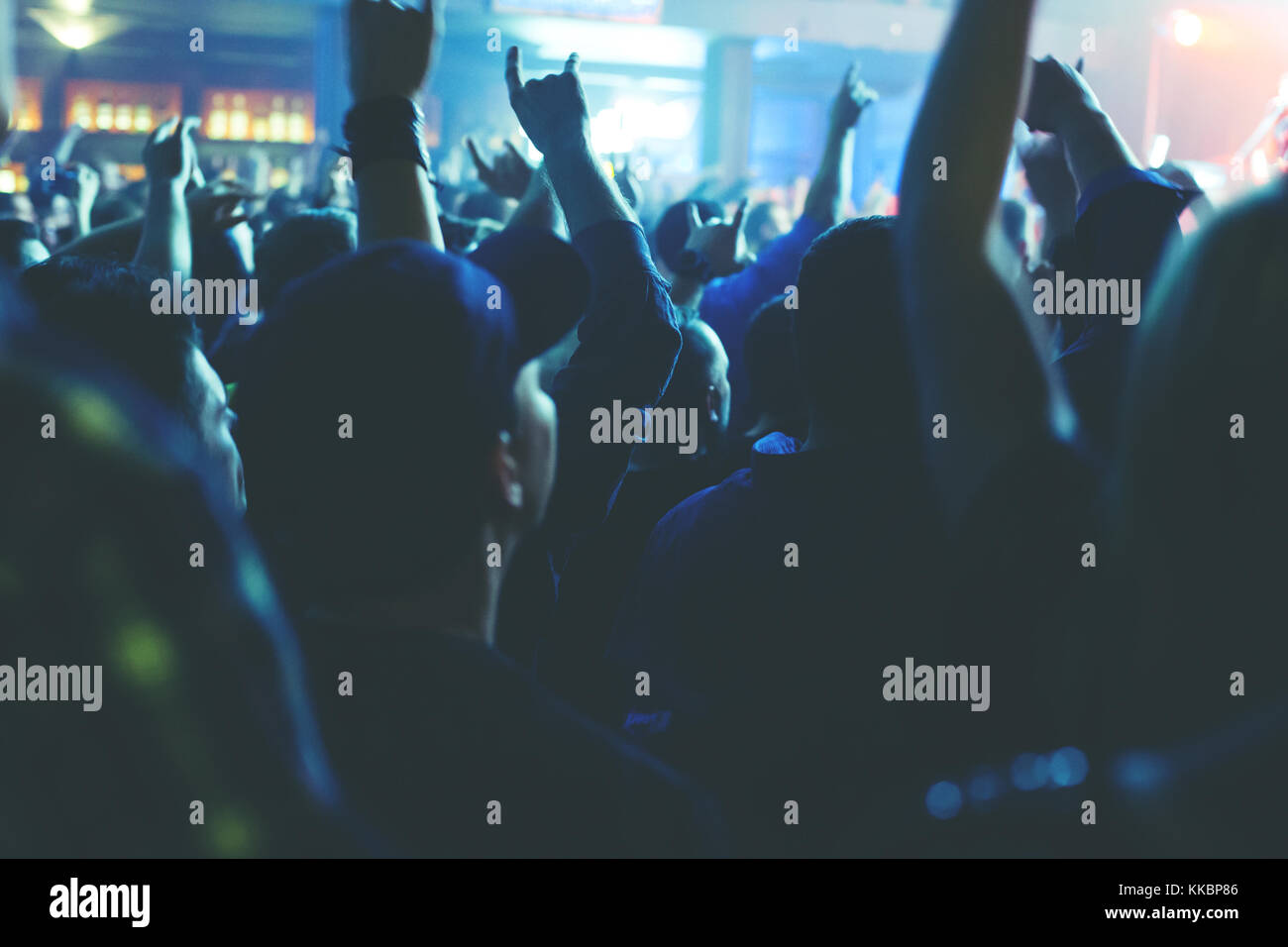 The audience watching the concert on stage in big concert club Stock ...
