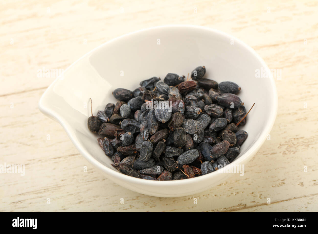 Dry barberry in the bowl over wooden background Stock Photo - Alamy