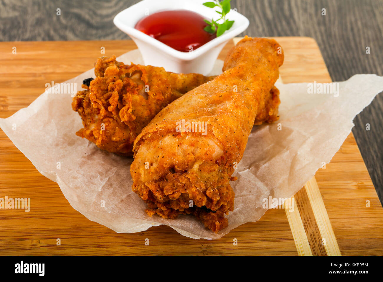 Crispy chicken legs with ketchup Stock Photo - Alamy