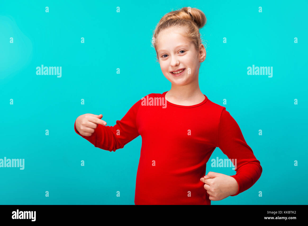 smiling little girl on blue background Stock Photo - Alamy