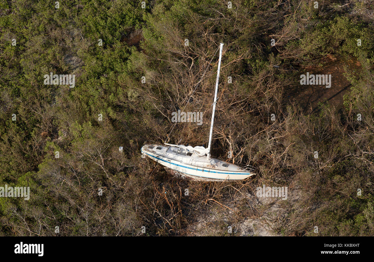 Aerial view of a stranded sailboat washed ashore in the aftermath of ...