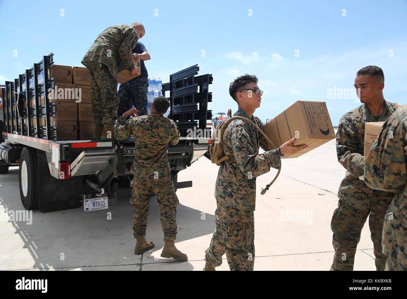 U.S. Marine Corps soldiers unload emergency supplies from a truck at ...