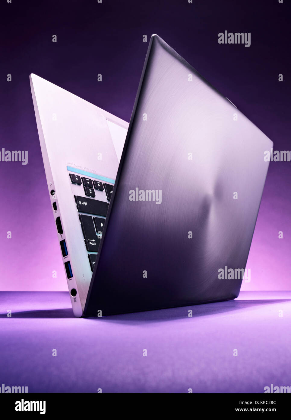 open laptop on a purple background Stock Photo - Alamy