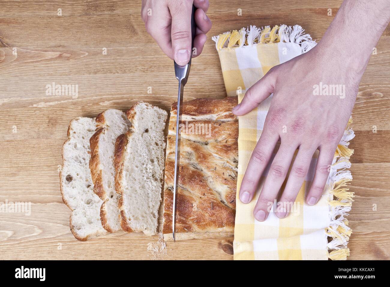 hands slicing bread loaf Stock Photo - Alamy