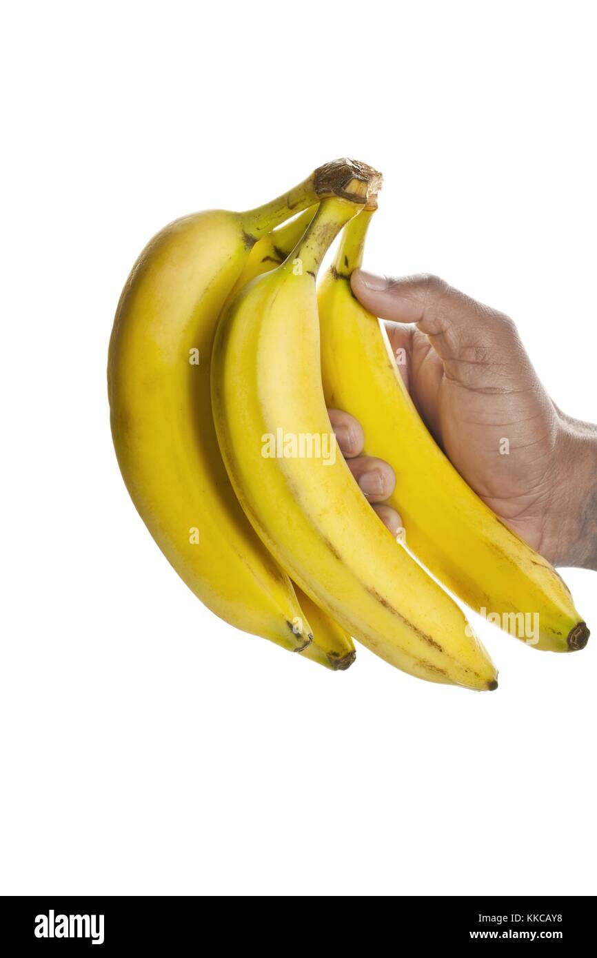 human hand holding bunch of banana Stock Photo - Alamy