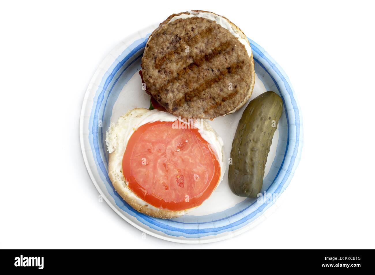 open burger with pickles on a plate Stock Photo - Alamy