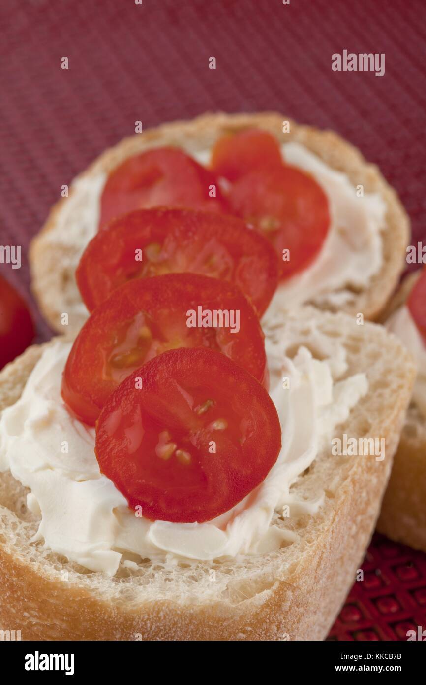 slice of bun with butter and tomato Stock Photo - Alamy