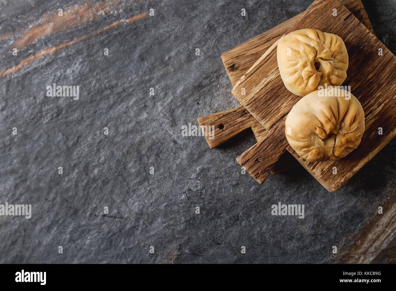 Traditional Russian meat pie, (belyashi) with sour cream. Dark ...