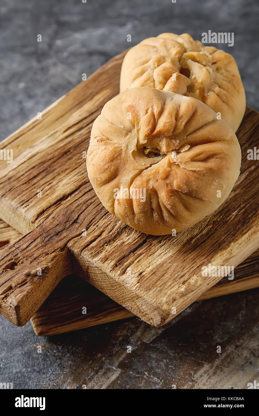 Traditional Russian meat pie, (belyashi) with sour cream. Dark ...