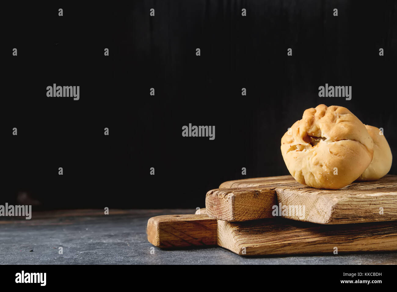 Traditional Russian meat pie, (belyashi). Dark background Stock Photo ...