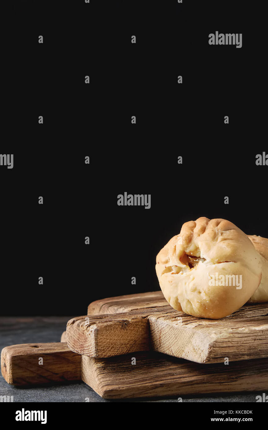 Traditional Russian meat pie, (belyashi). Dark background Stock Photo ...