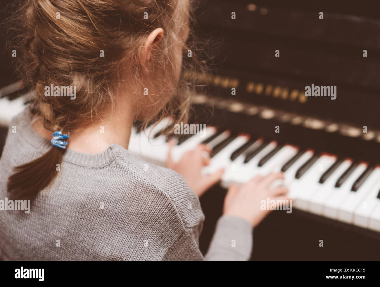 Little girl learning to play the piano Stock Photo - Alamy