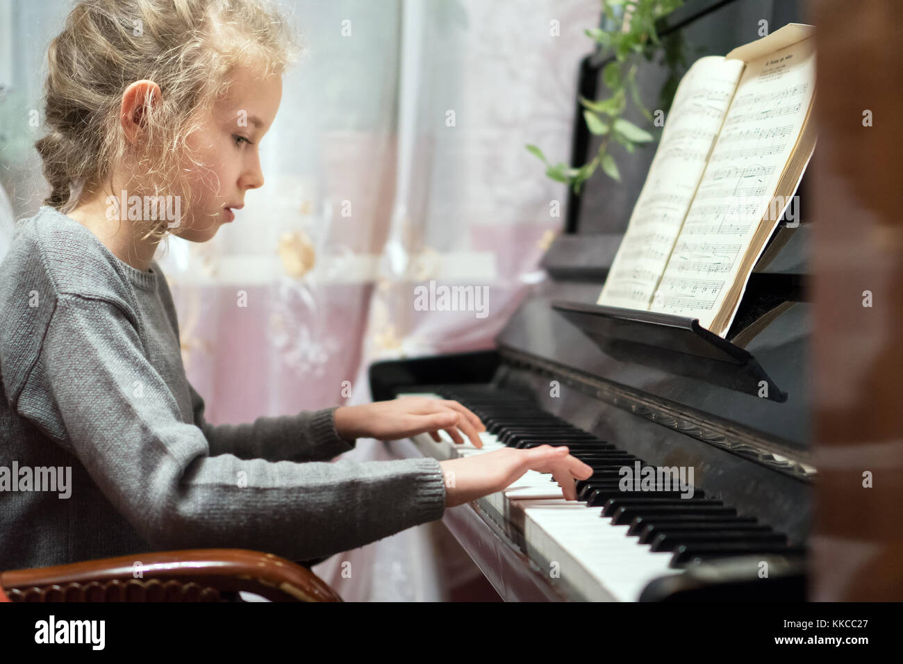 Little girl learning to play the piano Stock Photo - Alamy