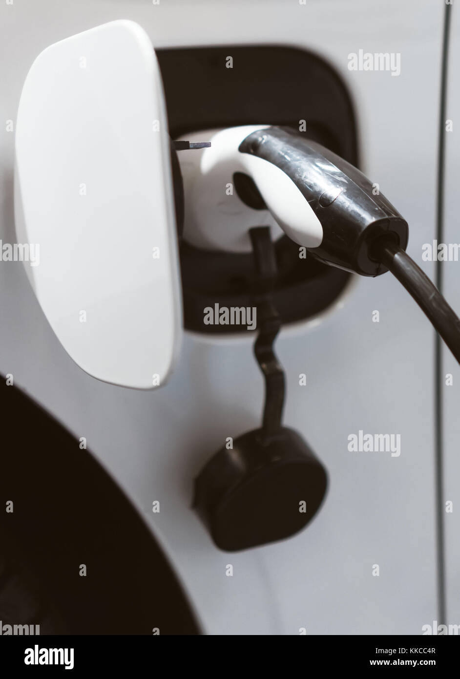 Electric plug charging white electric car Stock Photo - Alamy