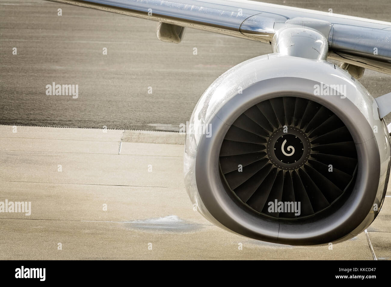 Close up shot of a jet engine of a modern airplane standing on a runway ...