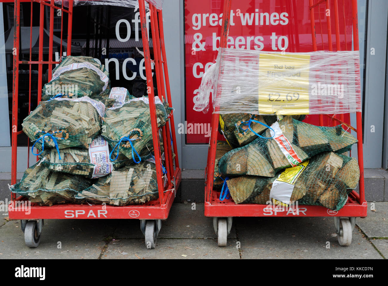 Kindling and firewood for sale in bags outside a Spar mini supermarket ...